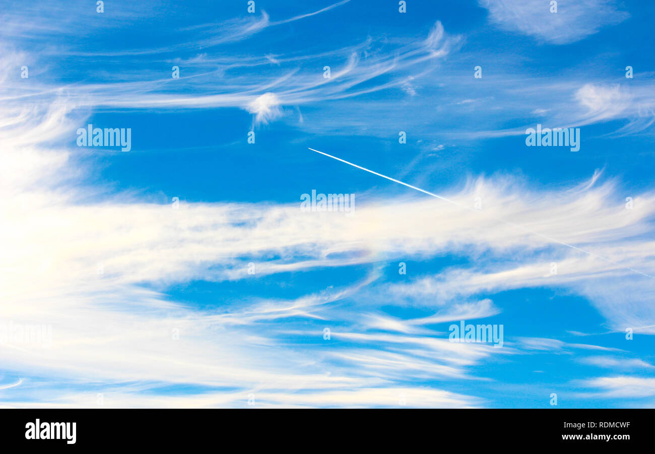 blue sky background with contrails and clouds Stock Photo - Alamy