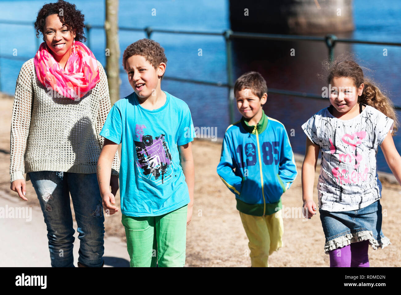 Mother walking with children Stock Photo - Alamy