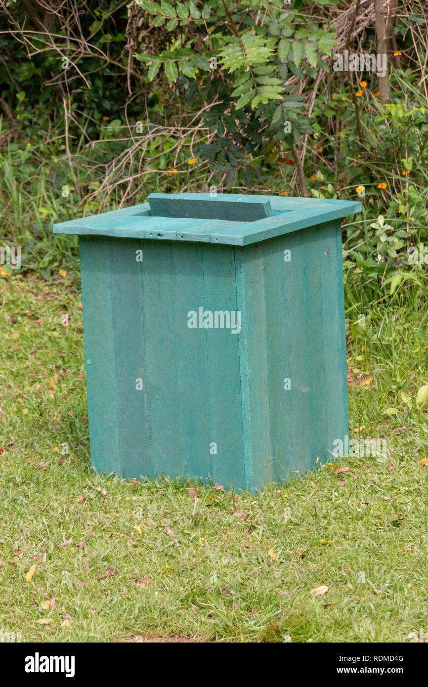 A close up front side view of a green recycled plastic rubbish bin in a ...