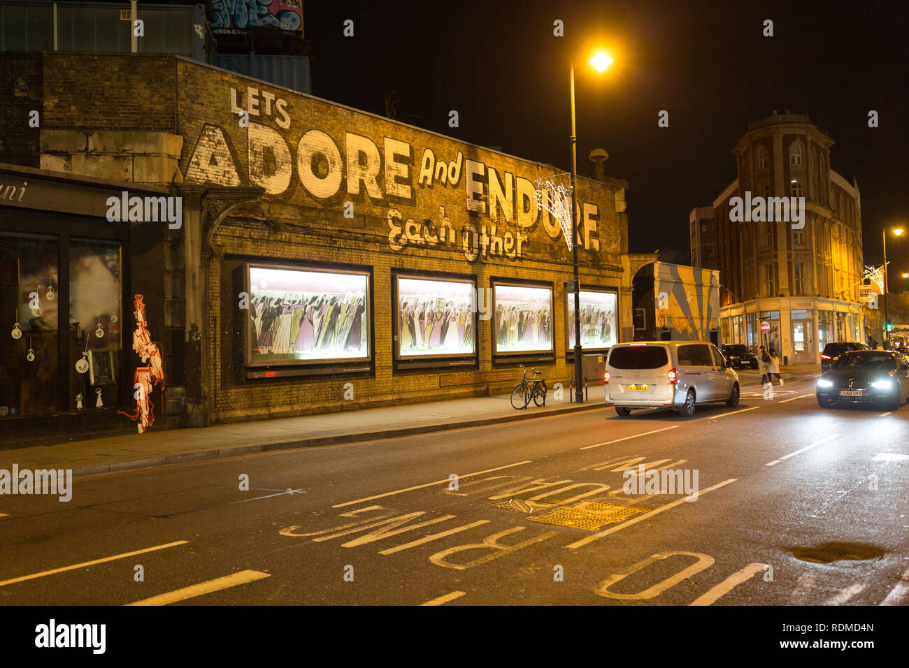 Let's Adore and Endure sign on a wall Stock Photo - Alamy
