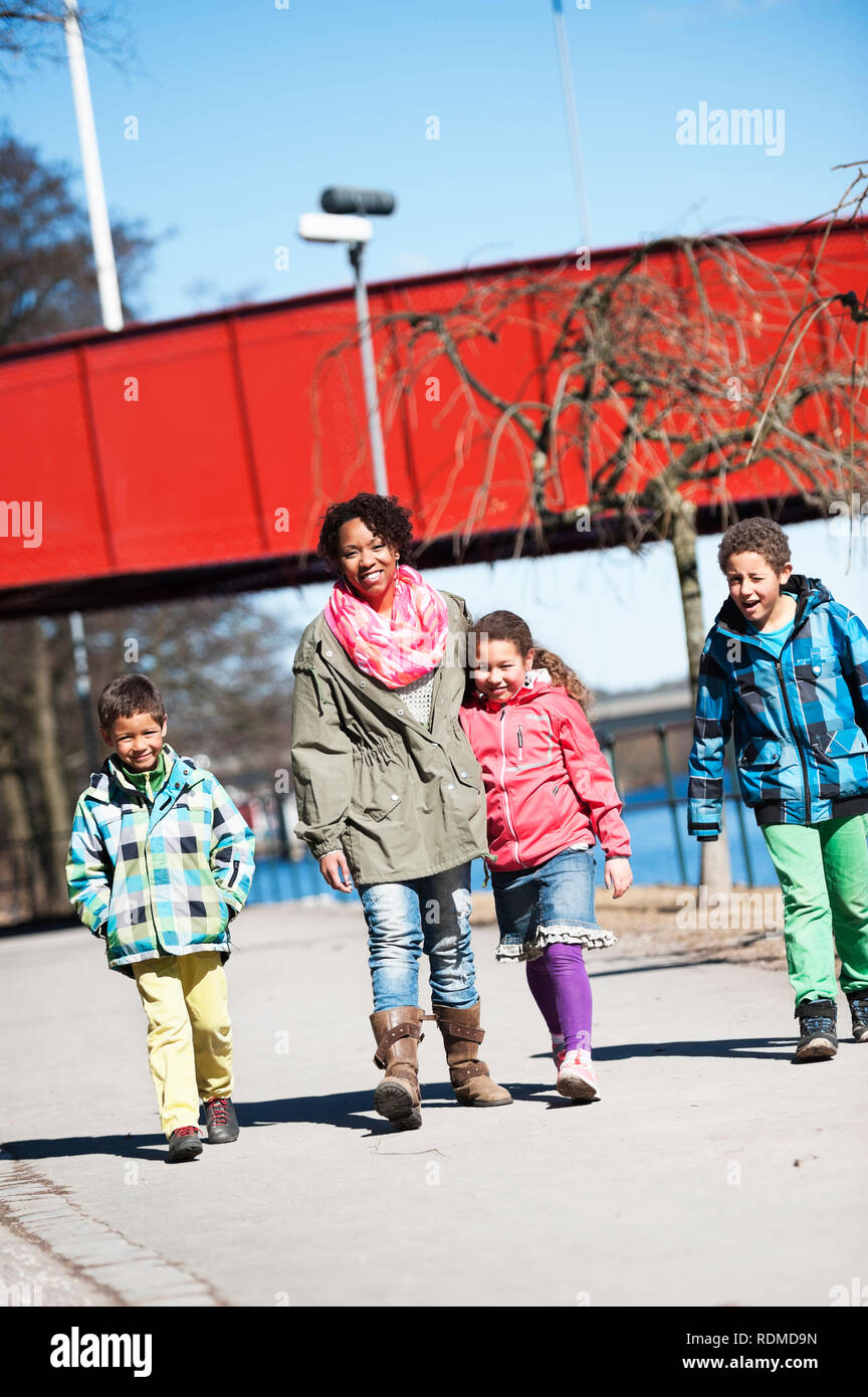 Mother walking with children Stock Photo - Alamy