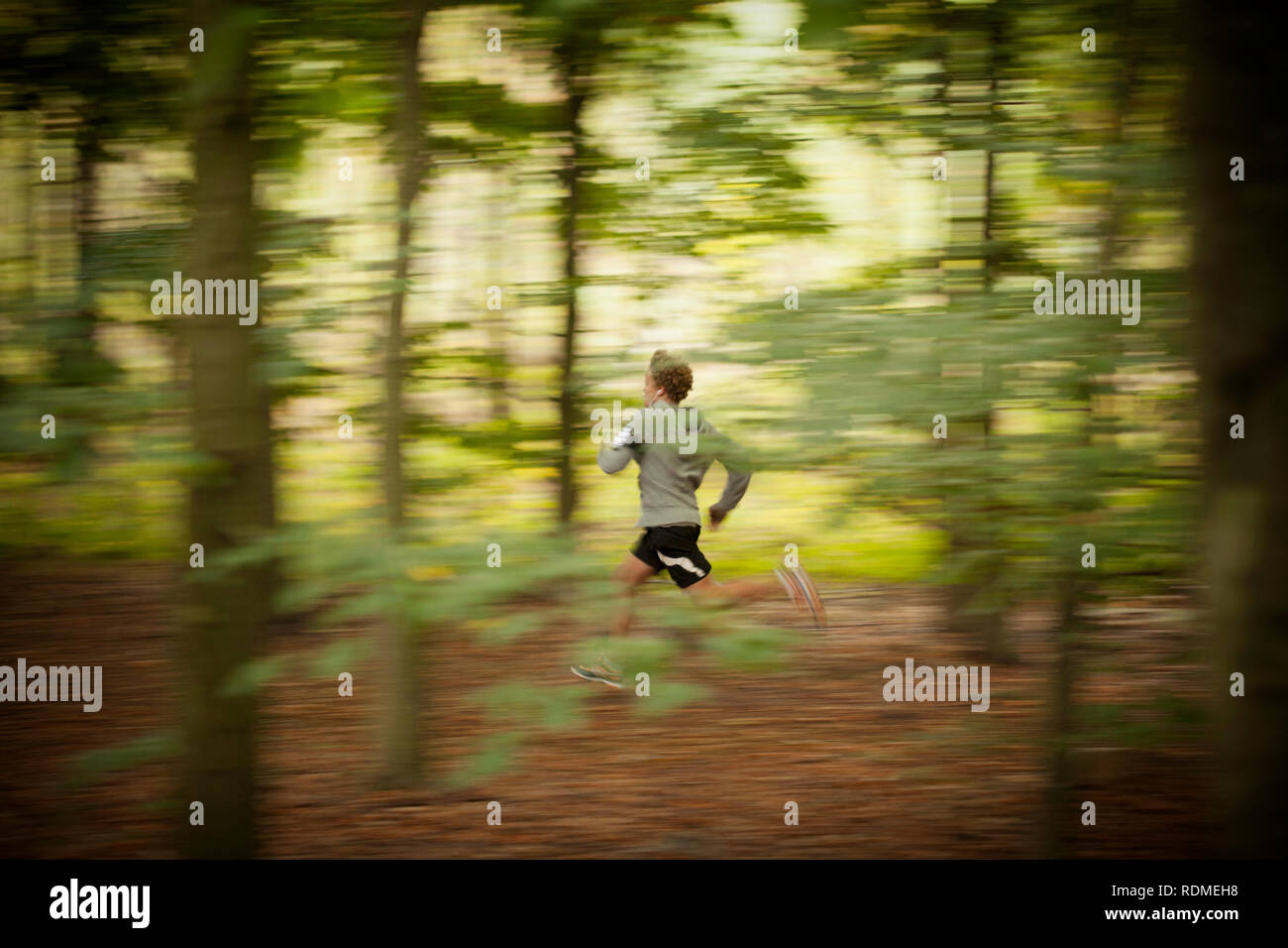 Man running in the forest Stock Photo - Alamy