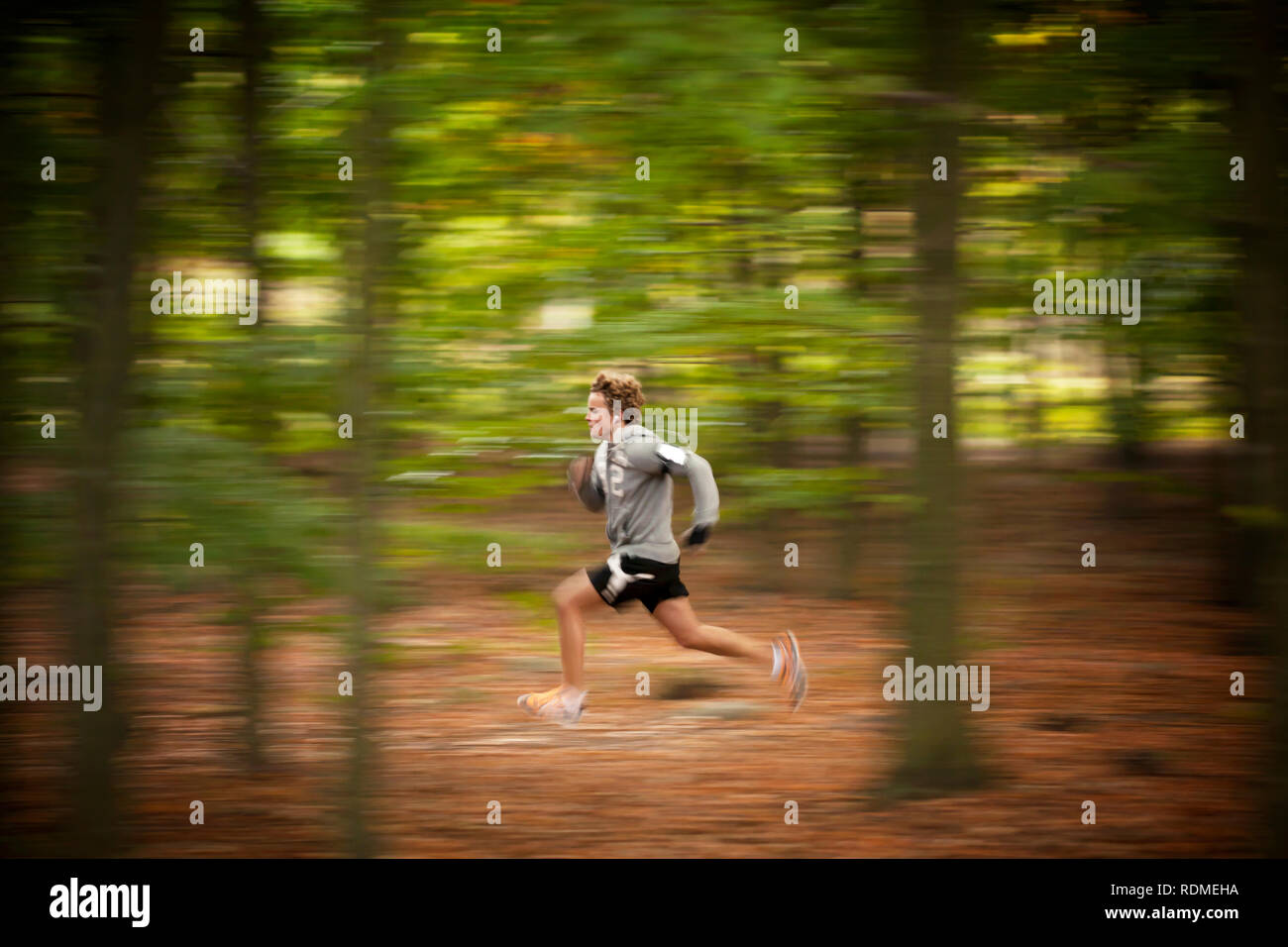 Man running in the forest Stock Photo - Alamy