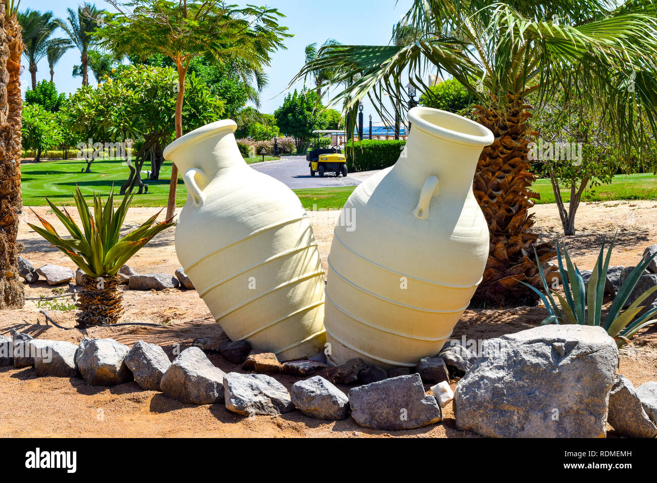 View into a park over two clay pots Stock Photo - Alamy