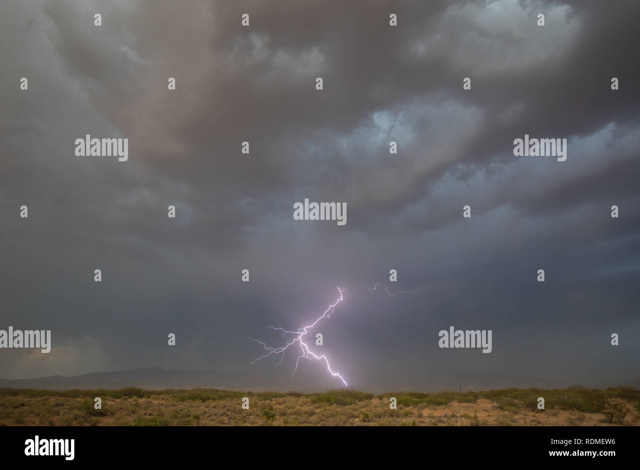Lightning strike with ragged clouds and dust in the Desert Southwest ...