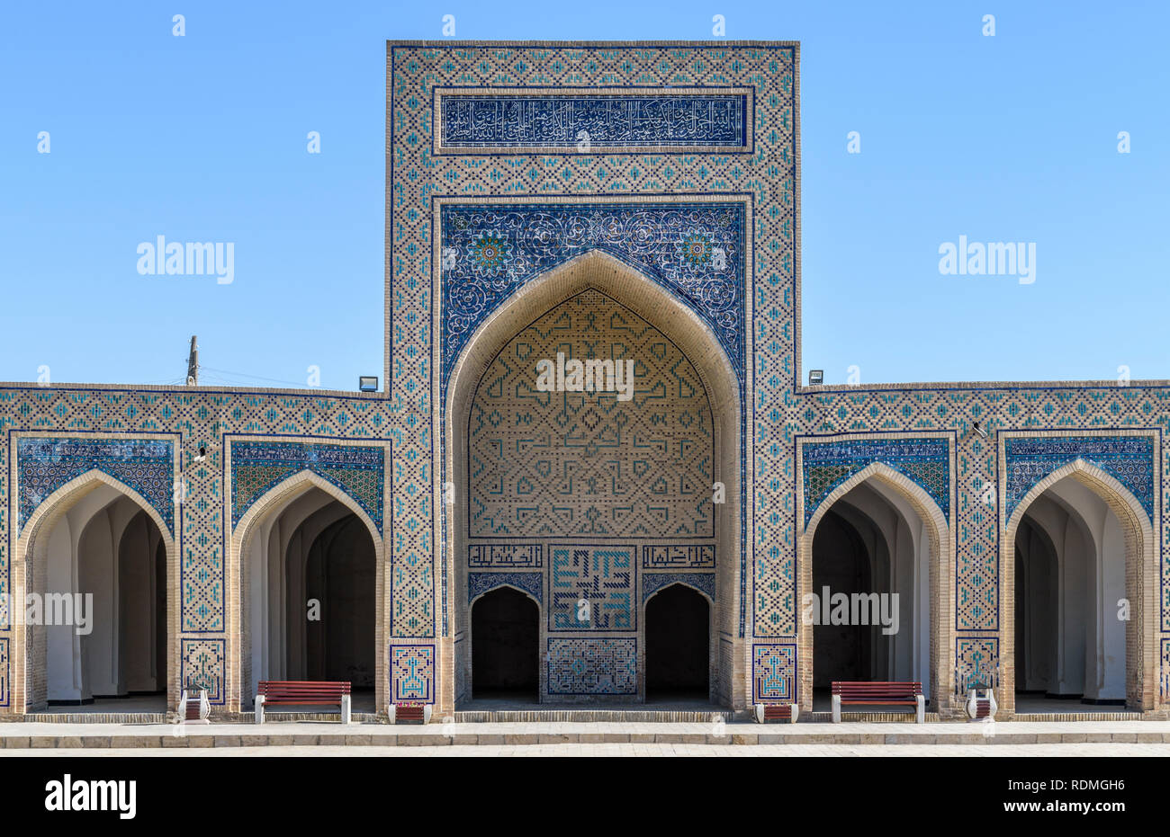 Madrasa facade with a tall arch and blue ceramic glazed tiles ...