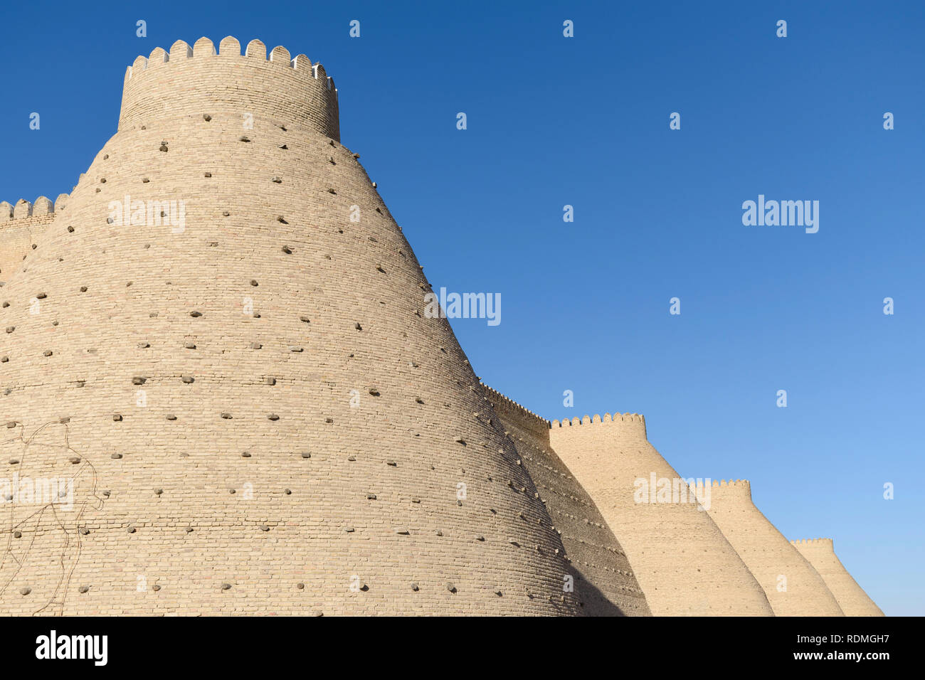Wall of the Bukhara Fortress, the Ark in Bukhara with tapering high ...