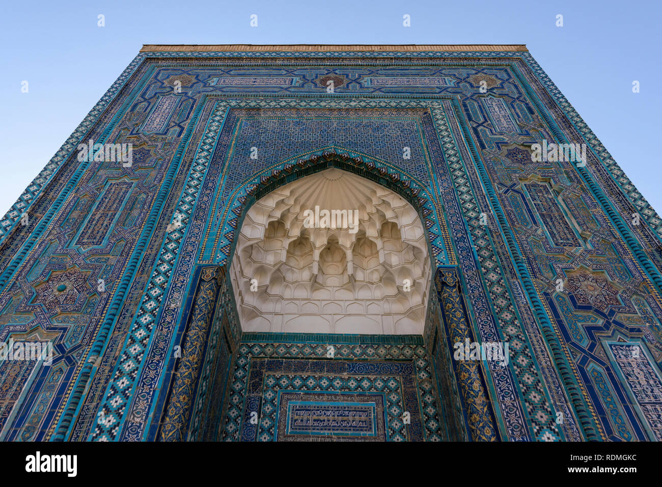 Registan square in Samarkand, a huge arch covered in glazed patterned ...