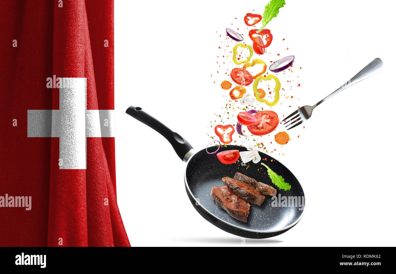 Frying pan with falling vegetables and meat, isolated objects. On the ...