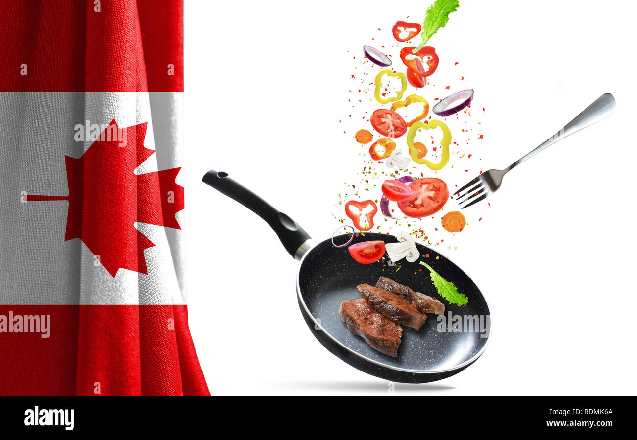 Frying pan with falling vegetables and meat, isolated objects. On the ...