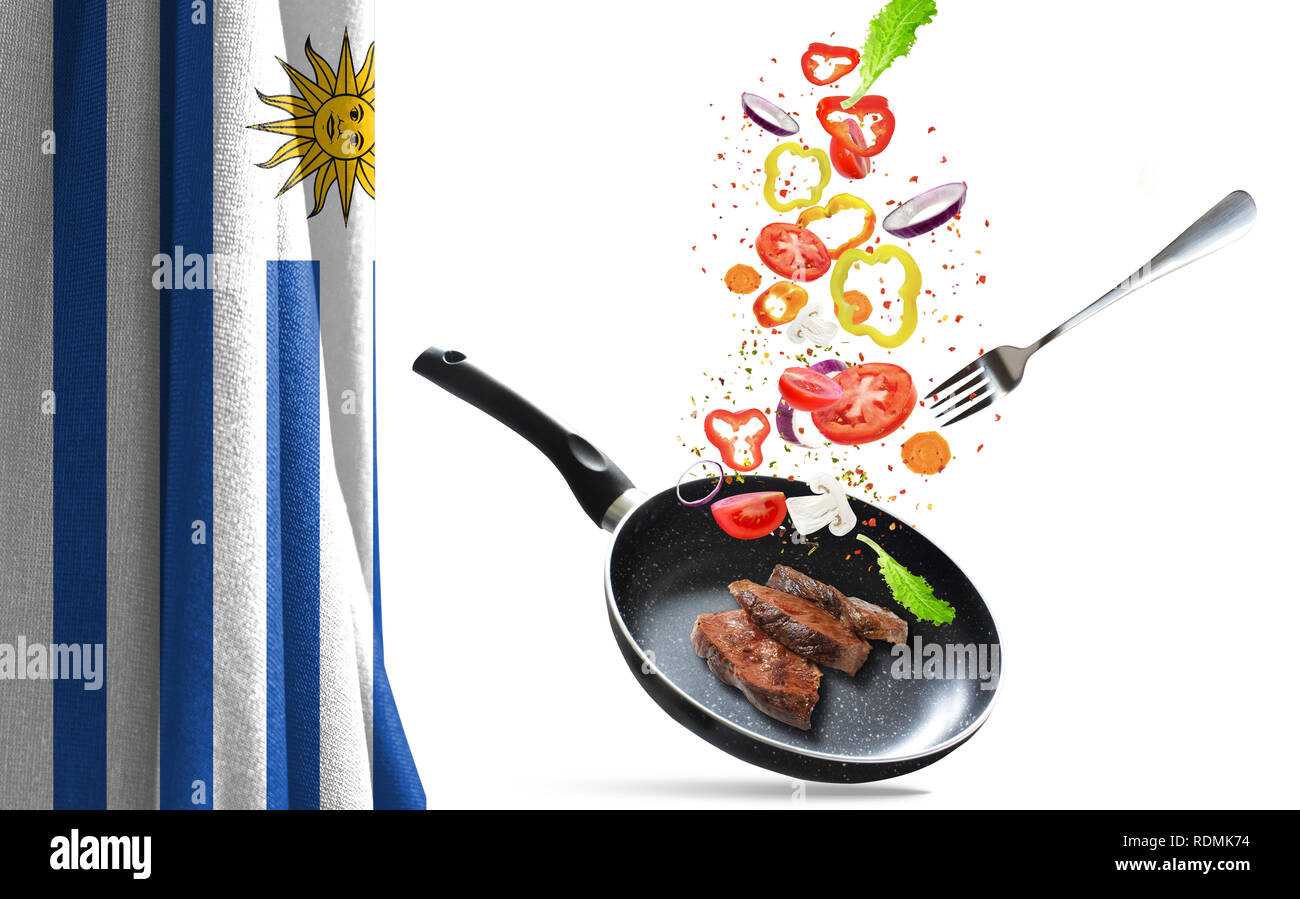 Frying pan with falling vegetables and meat, isolated objects. On the ...