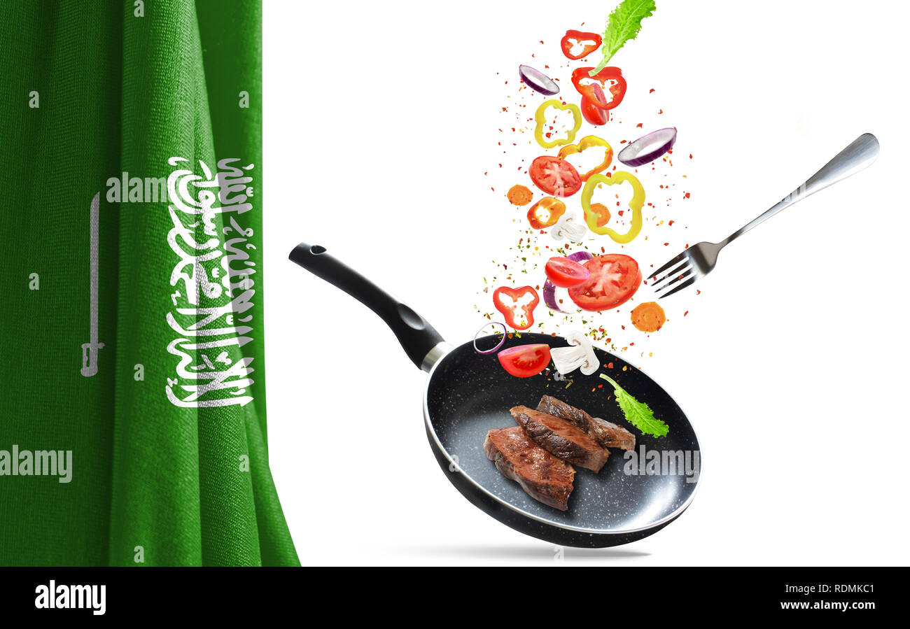 Frying pan with falling vegetables and meat, isolated objects. On the ...