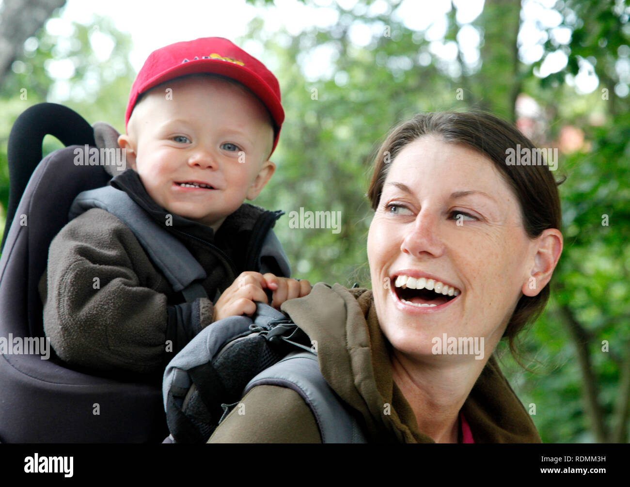 Mothera with son in baby carrier Stock Photo - Alamy