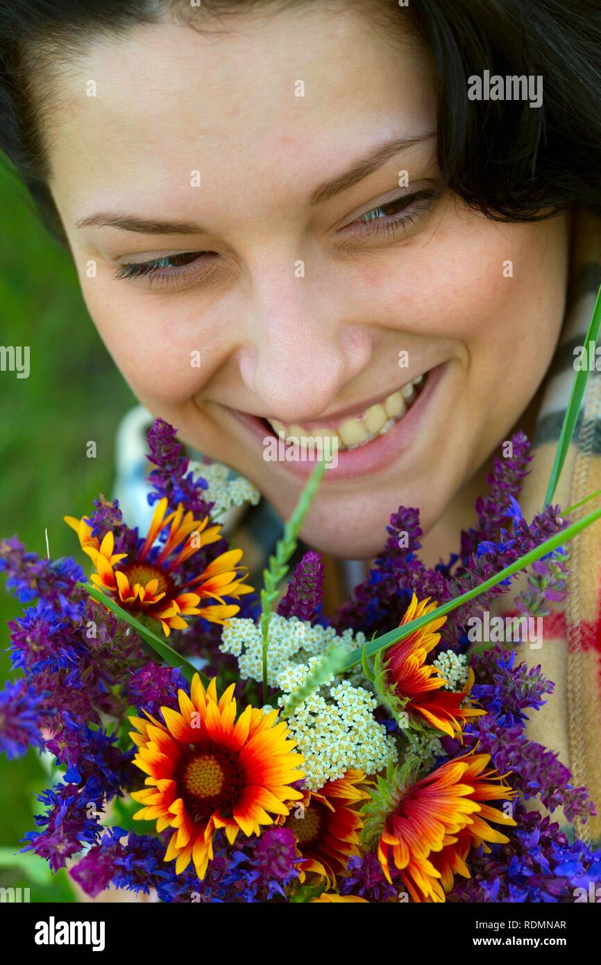 girl with bouquet of salvia and camomile Stock Photo - Alamy