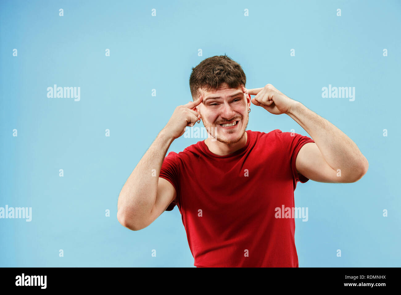 Young boy with a surprised unhappy failure expression bet slip on blue ...