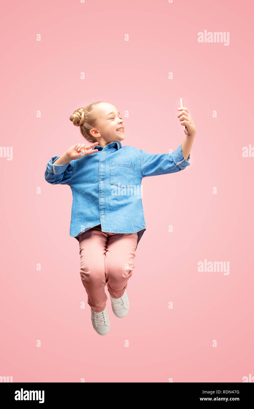 Young scared surprised caucasian teen girl jumping in the air, isolated ...