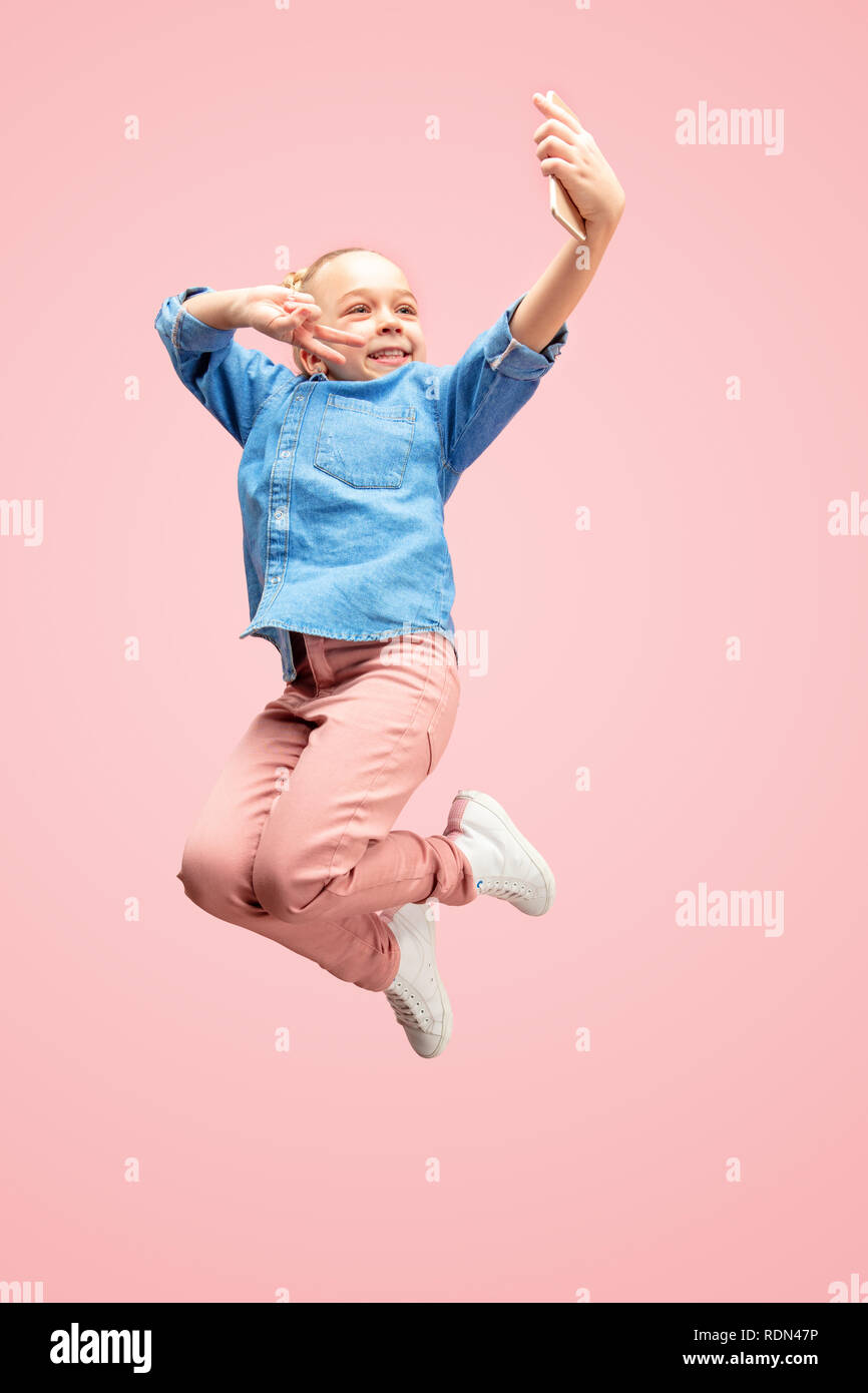 Young scared surprised caucasian teen girl jumping in the air, isolated ...