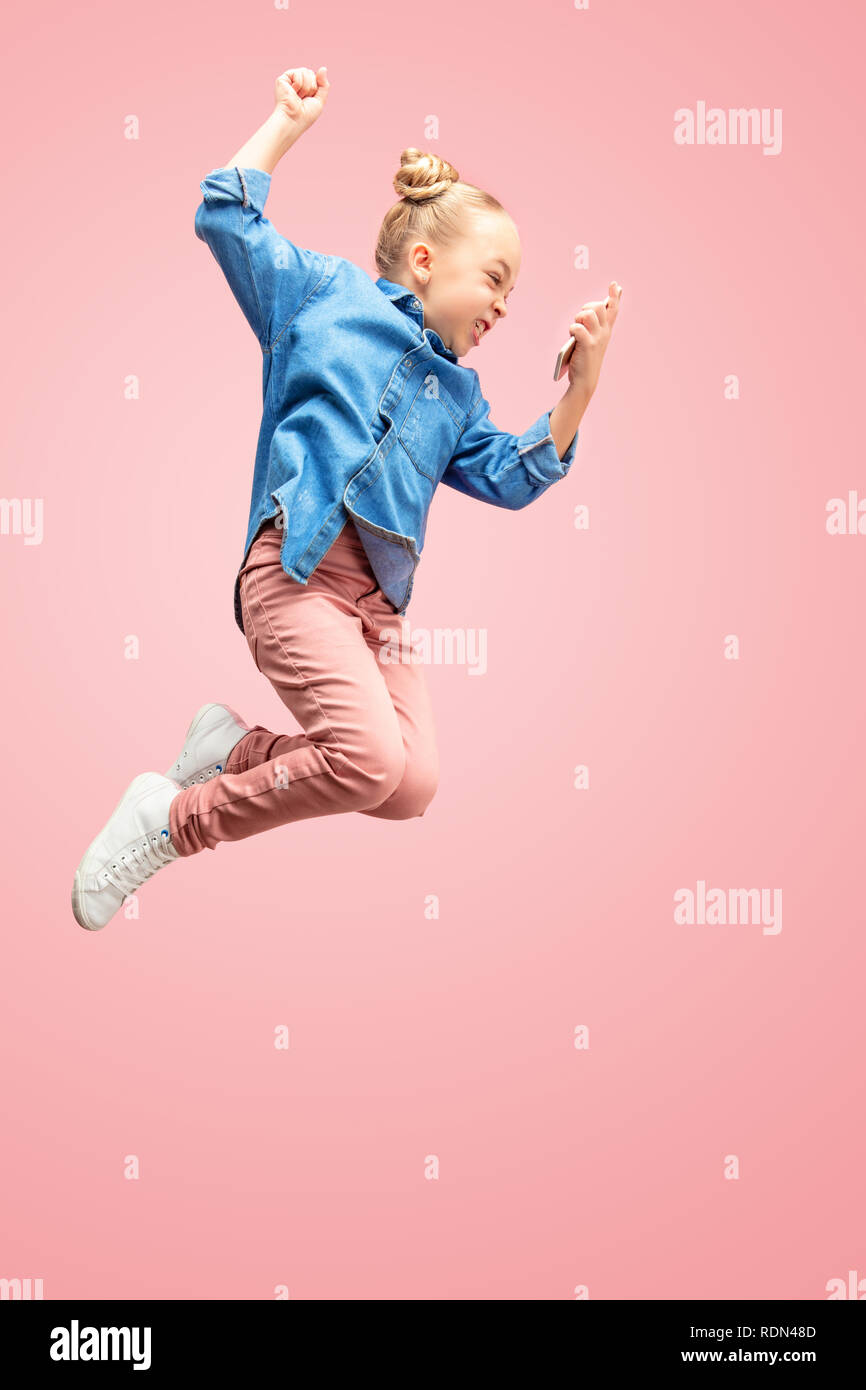 Young scared surprised caucasian teen girl jumping in the air, isolated ...