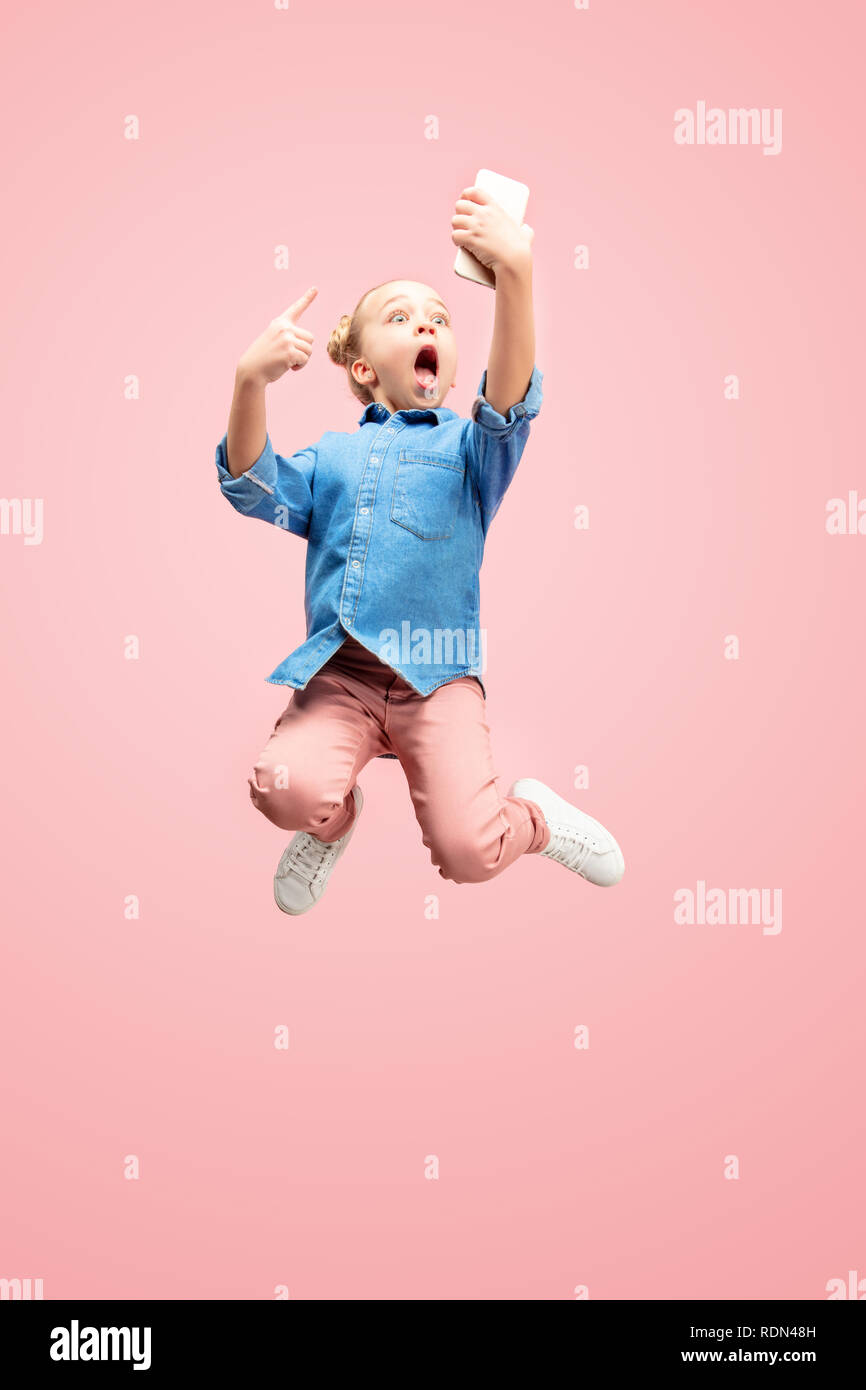 Young scared surprised caucasian teen girl jumping in the air, isolated ...