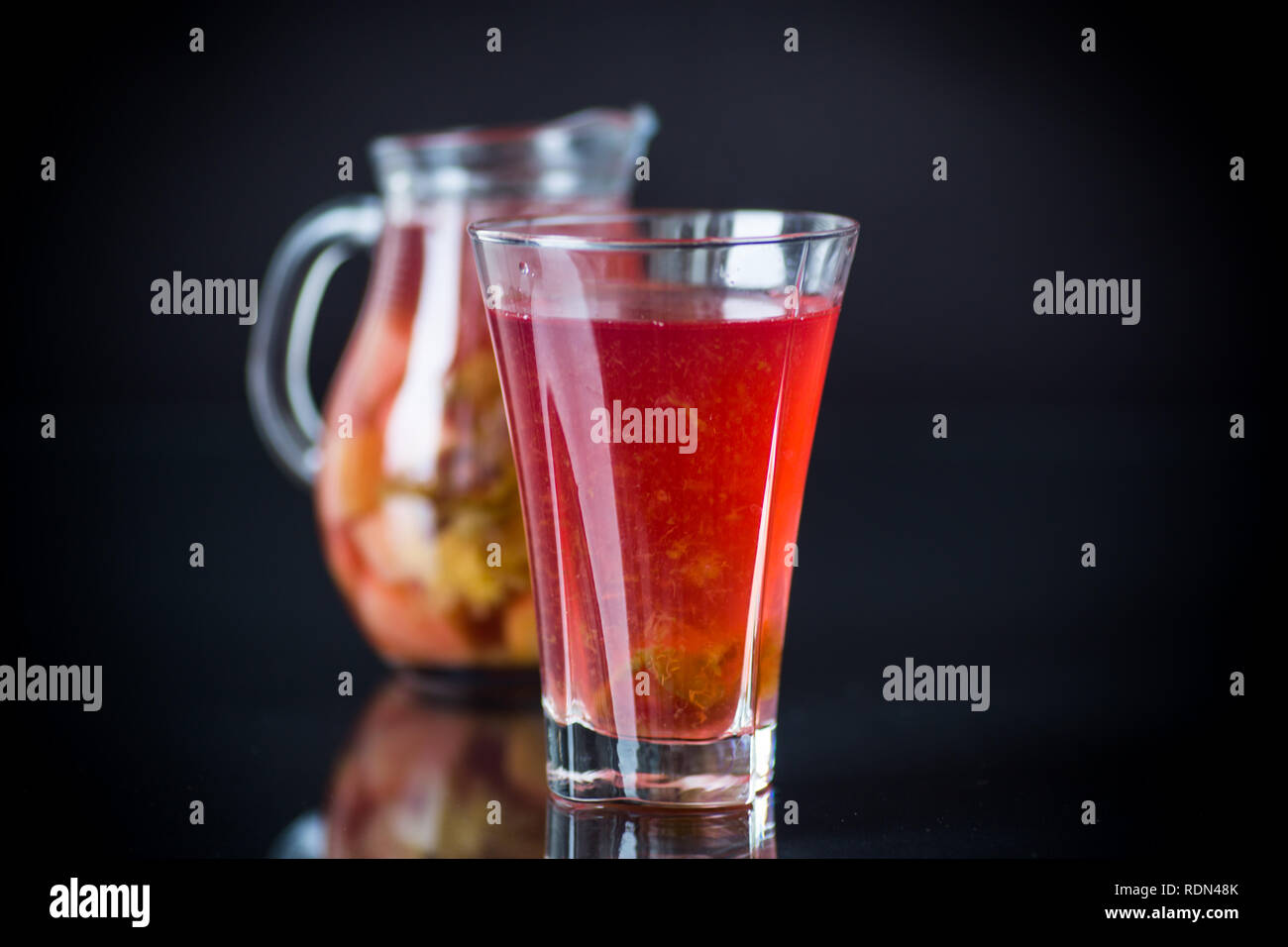 red fruit compote in a decanter with a glass Stock Photo - Alamy
