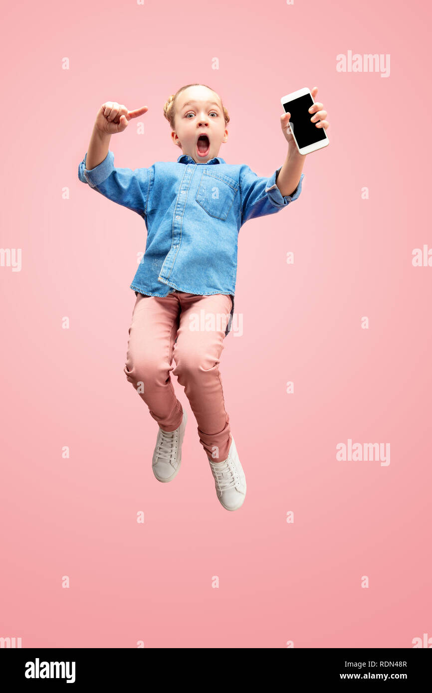 Young scared surprised caucasian teen girl jumping in the air, isolated ...