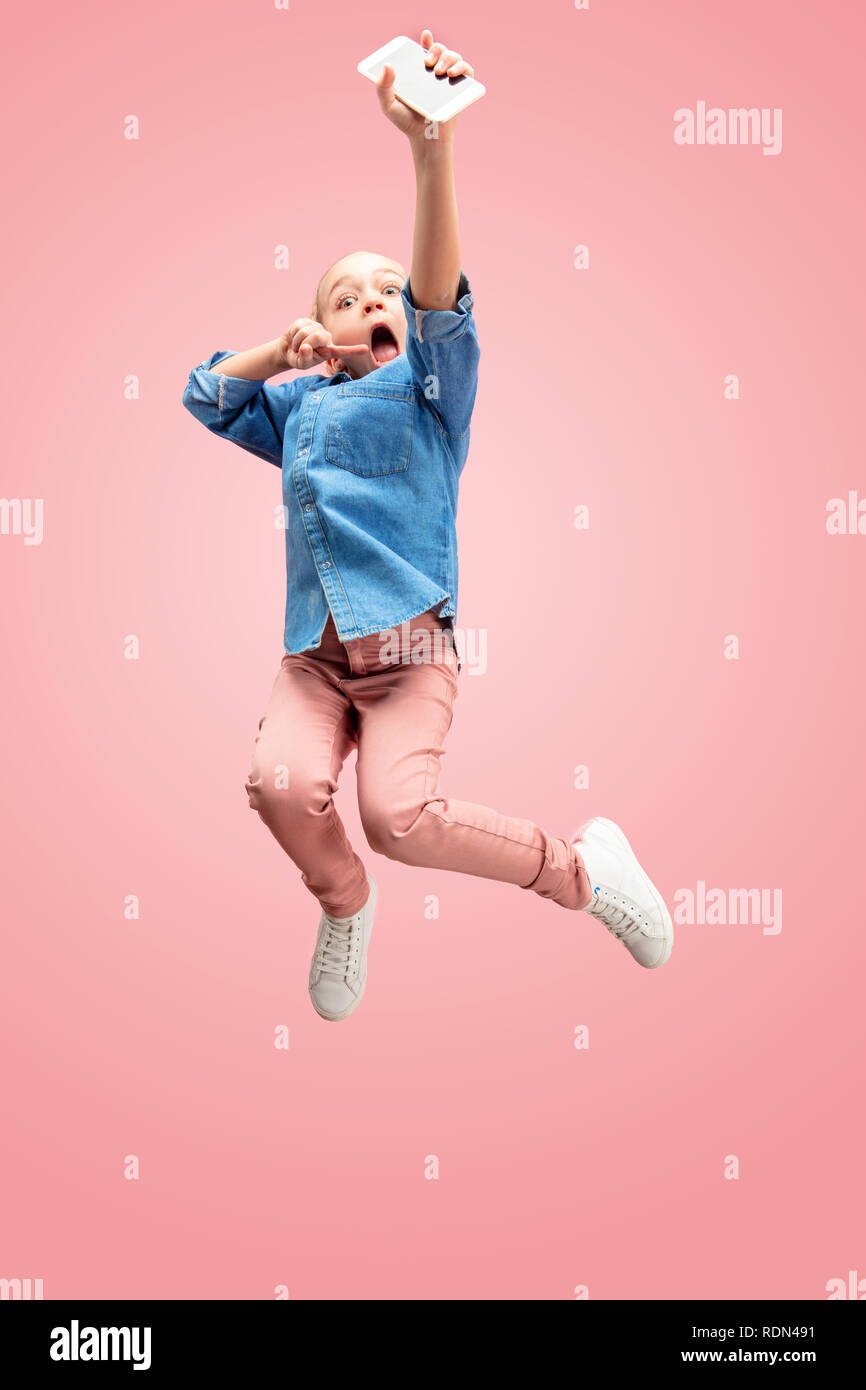 Young scared surprised caucasian teen girl jumping in the air, isolated ...