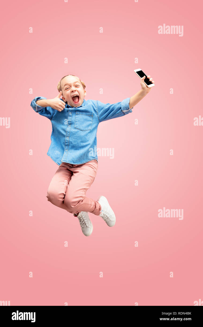 Young scared surprised caucasian teen girl jumping in the air, isolated ...