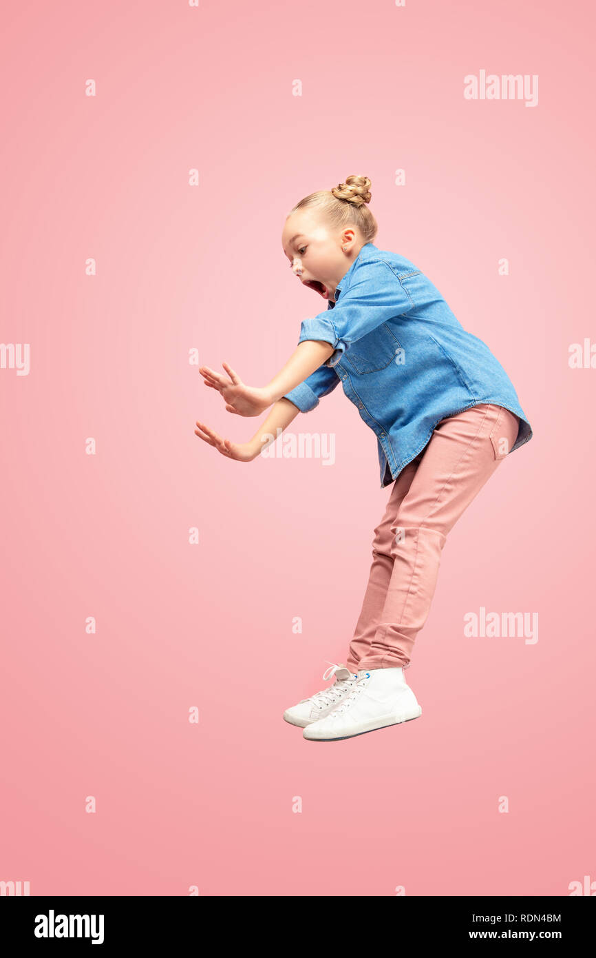 Young scared surprised caucasian teen girl jumping in the air, isolated ...