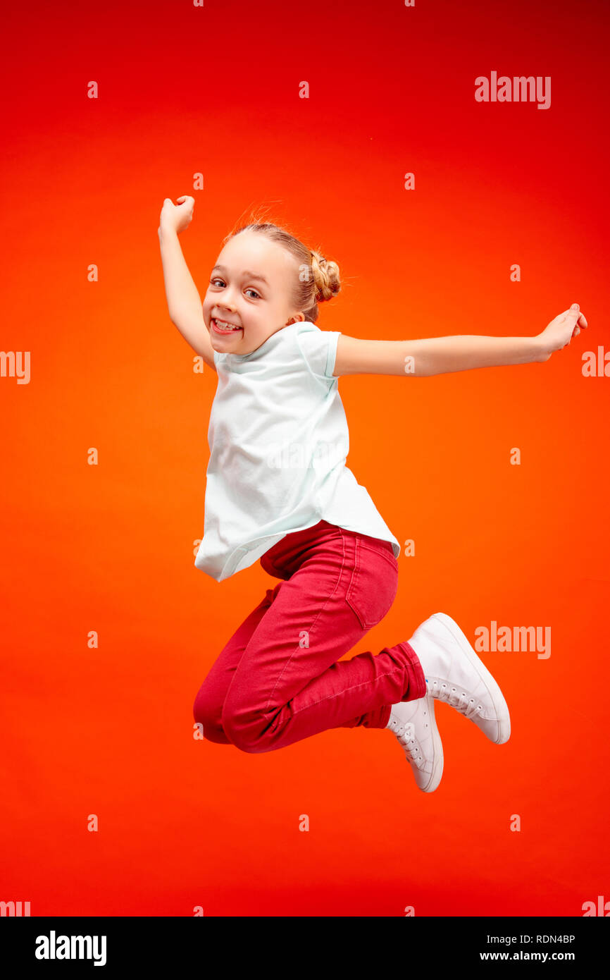 Young scared surprised caucasian teen girl jumping in the air, isolated ...