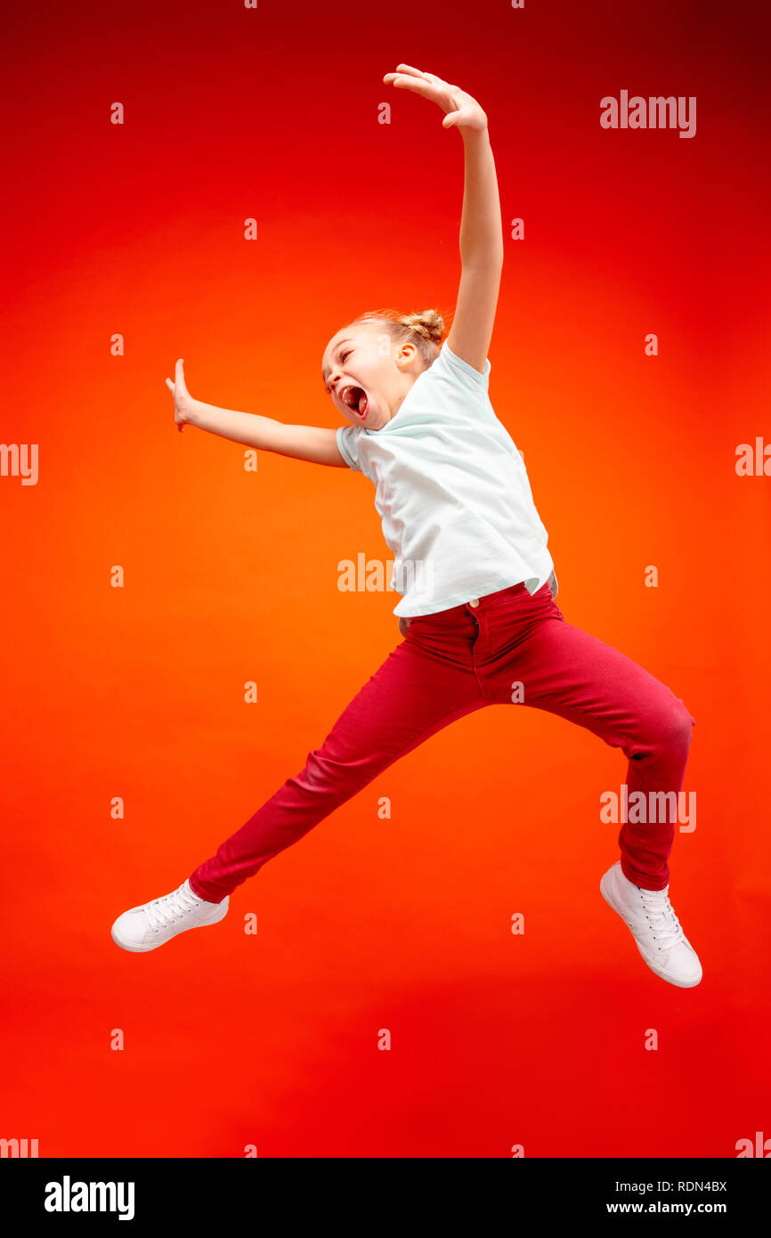 Young scared surprised caucasian teen girl jumping in the air, isolated ...