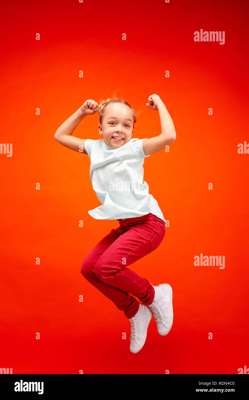 Young scared surprised caucasian teen girl jumping in the air, isolated ...