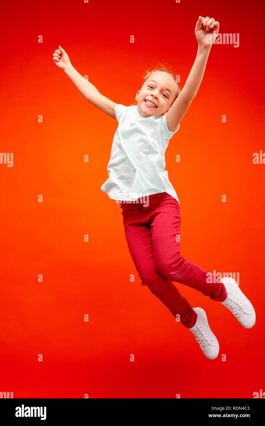 Young scared surprised caucasian teen girl jumping in the air, isolated ...
