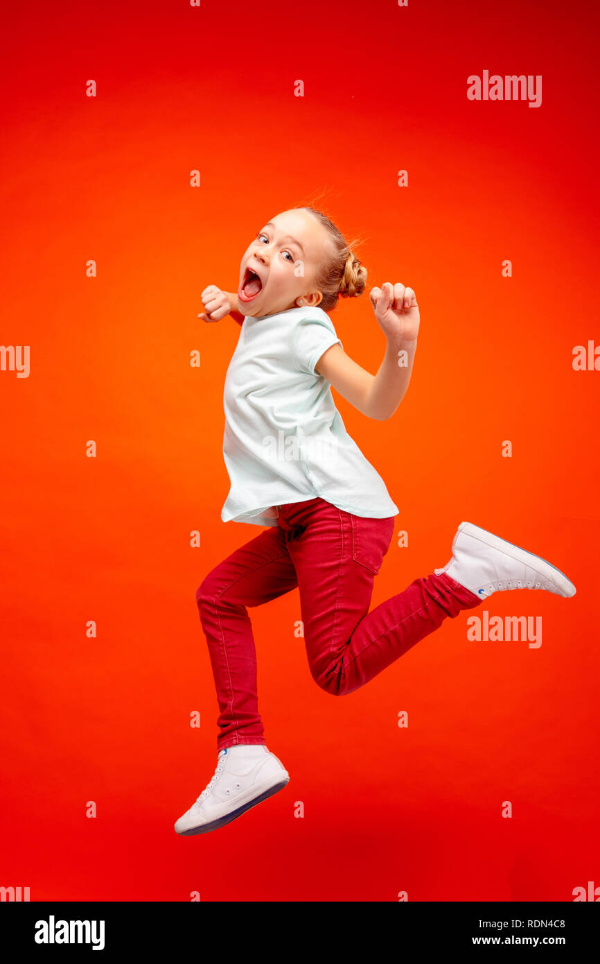Young scared surprised caucasian teen girl jumping in the air, isolated ...