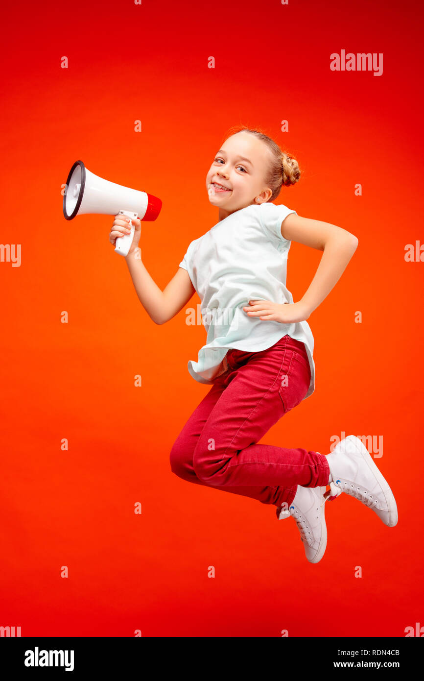 Young scared surprised caucasian teen girl jumping in the air, isolated ...