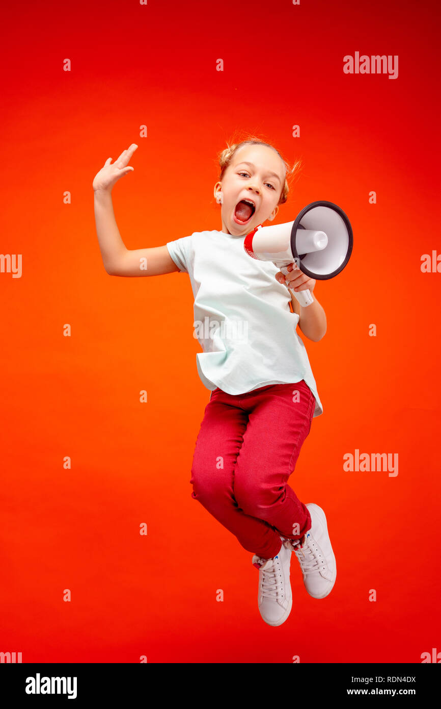 Young scared surprised caucasian teen girl jumping in the air, isolated ...