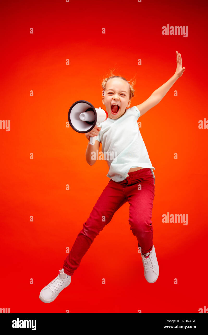 Young scared surprised caucasian teen girl jumping in the air, isolated ...