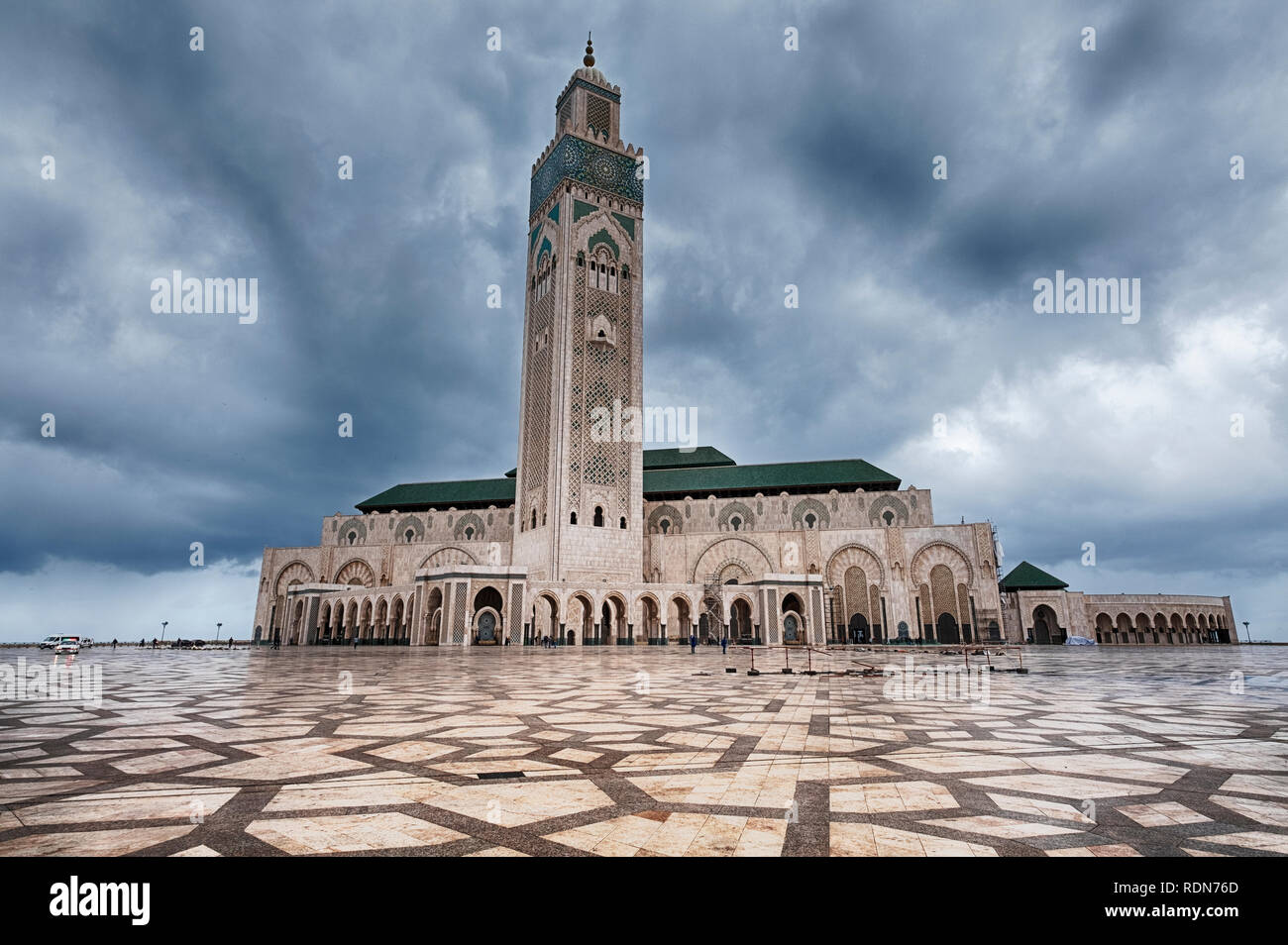 Viewed over a huge plaza made of granite stone on a dark and cloudy day ...