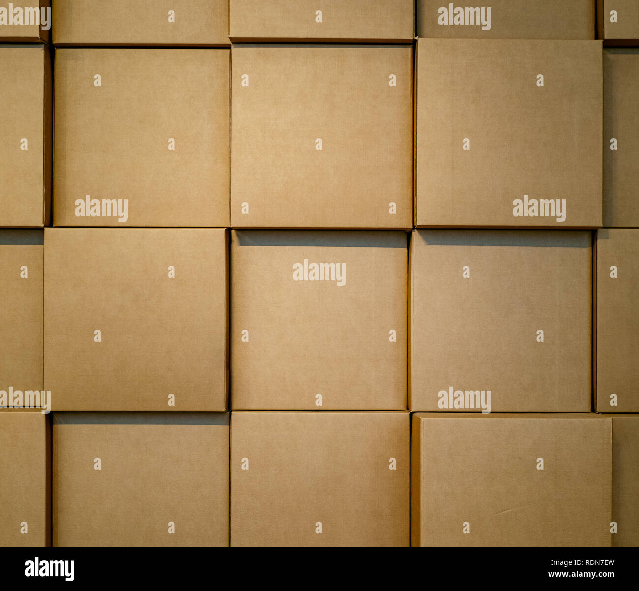 Cardboard boxes stacked in a wall. Background Stock Photo - Alamy