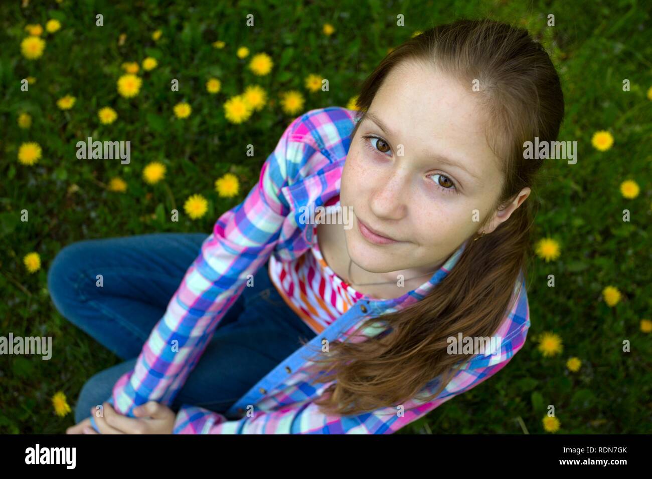 blonde girl sitting on grass outdoors Stock Photo - Alamy