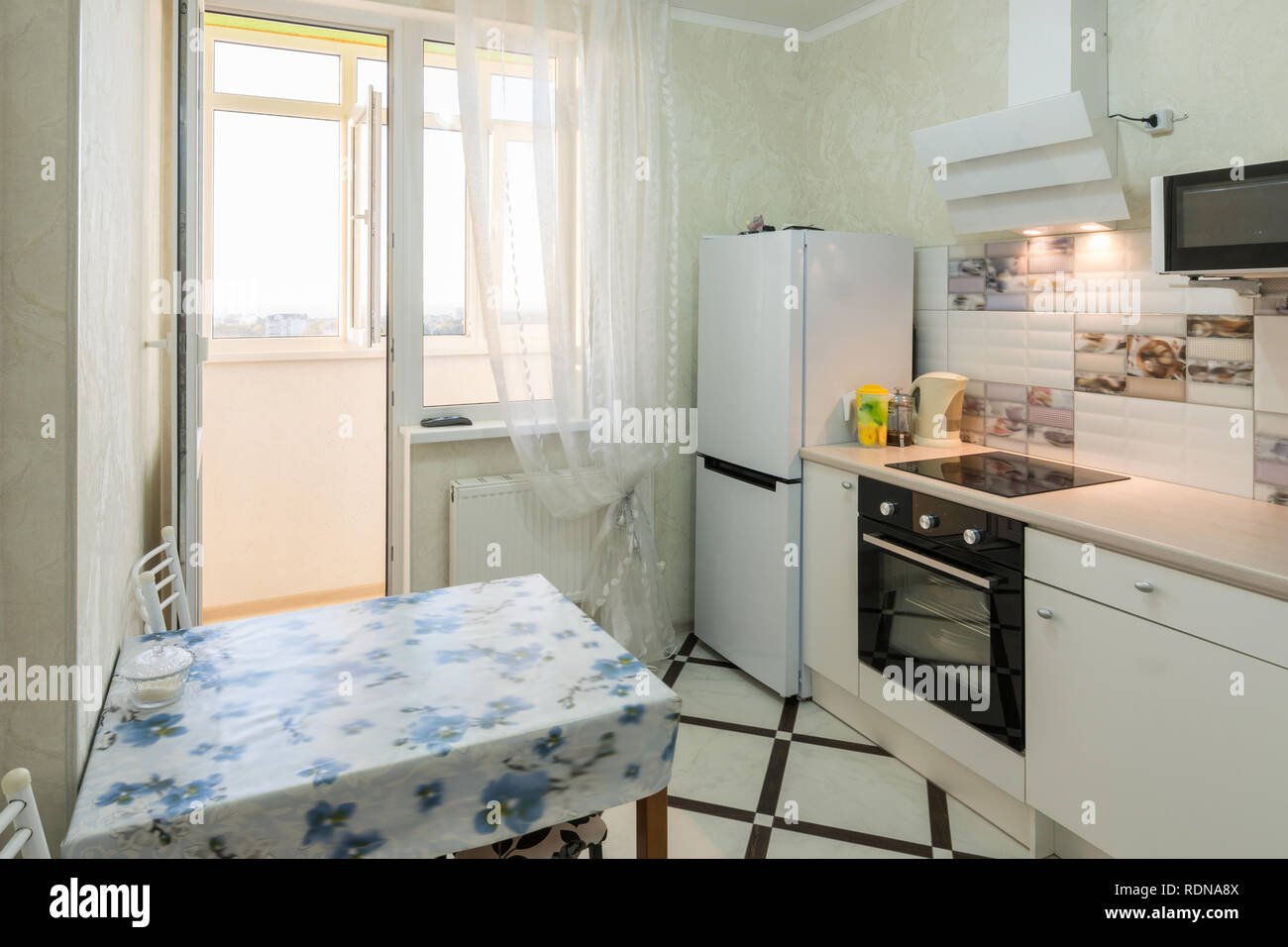 The interior of a small kitchen with a balcony Stock Photo - Alamy