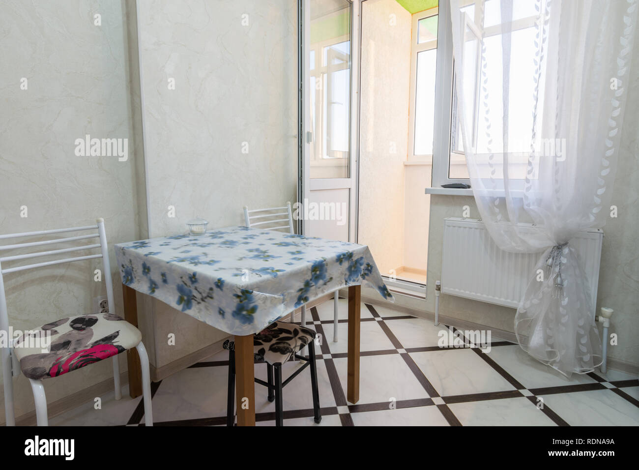 A small kitchen table stands near the balcony Stock Photo - Alamy