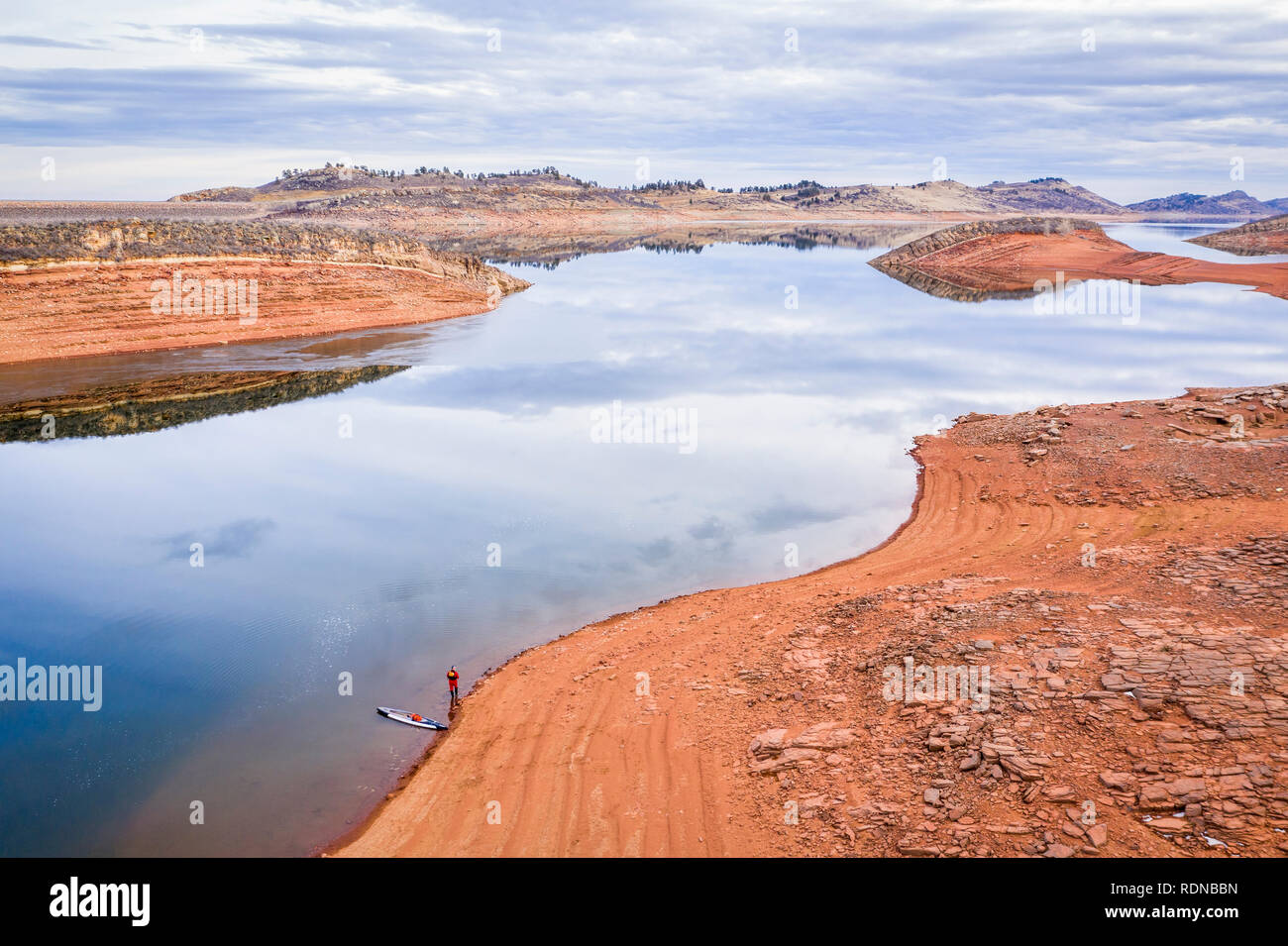 Aerial view of mountain lake with a stand up paddler, typical winter ...