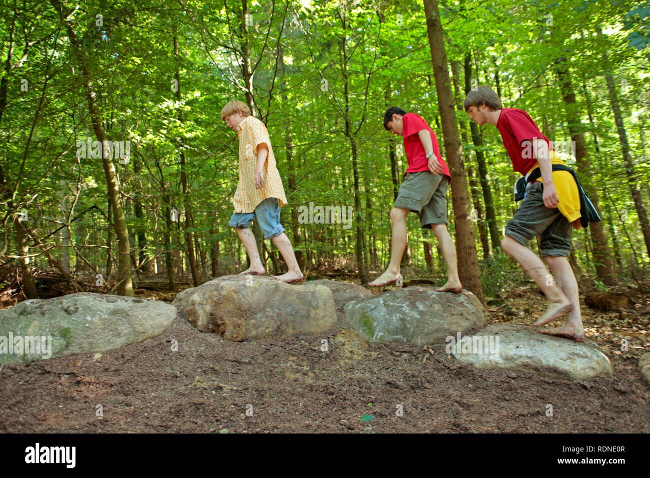 Young people walking along a barefoot path in Egestorf on the Lueneburg ...