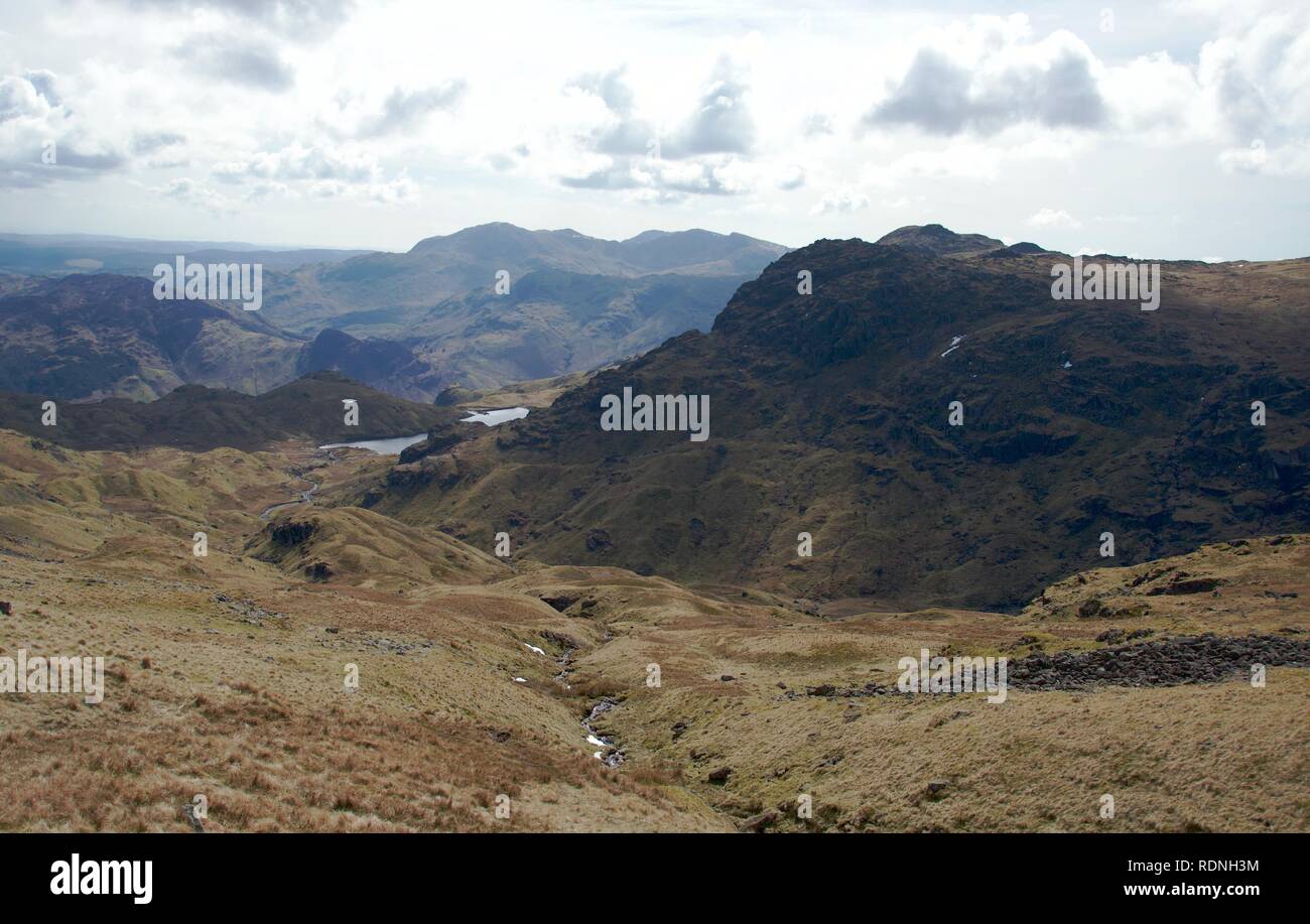 View across shoulder of Langdale Pikes. Tarn (pond / lake) and valleys ...