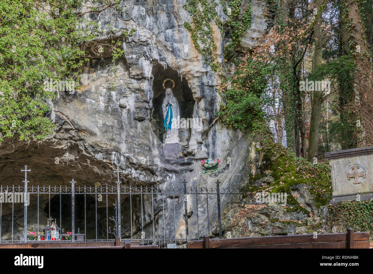 the replica of the Virgin of Lourdes in a natural grotto with a metal ...