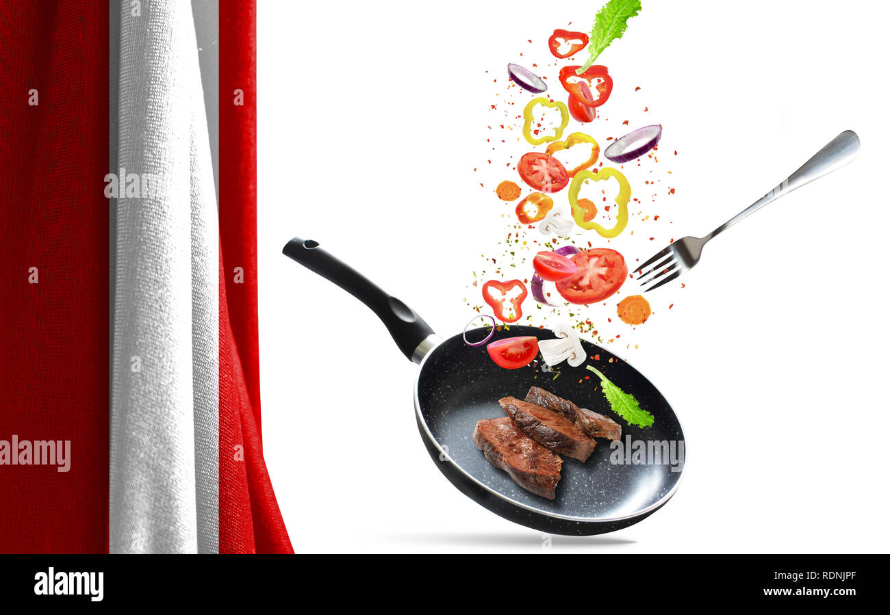 Frying pan with falling vegetables and meat, isolated objects. On the ...