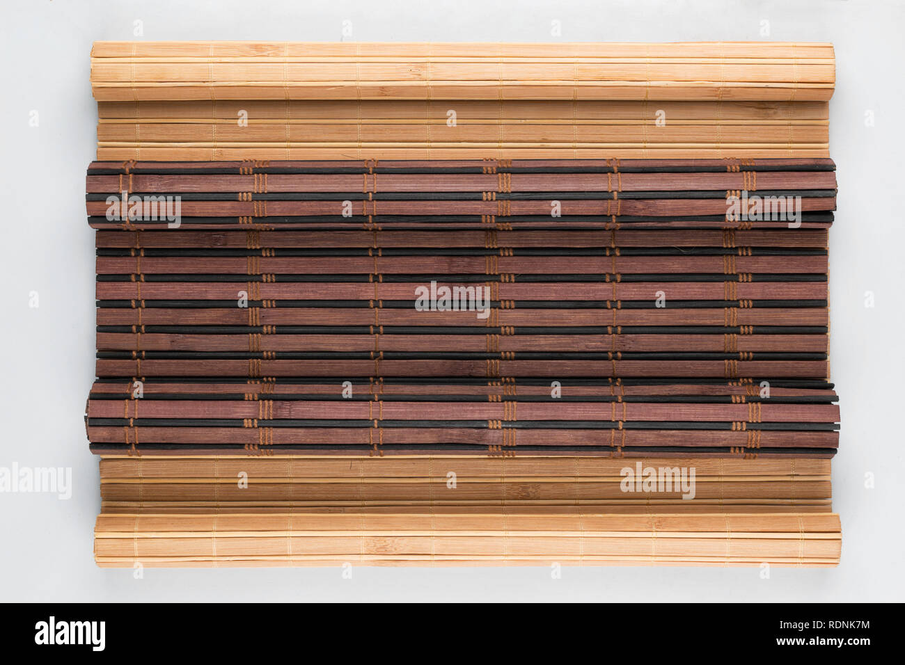 Bamboo mat with curled edges on white background. View from above Stock ...
