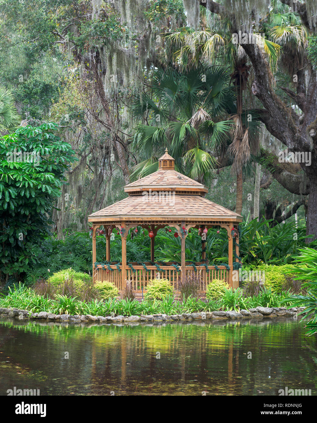 Gazebo along pond under oak tree at Washington Oaks Gardens State Park ...