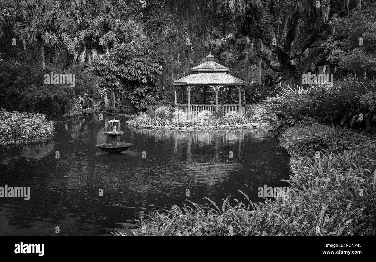 Gazebo along pond under oak tree at Washington Oaks Gardens State Park ...