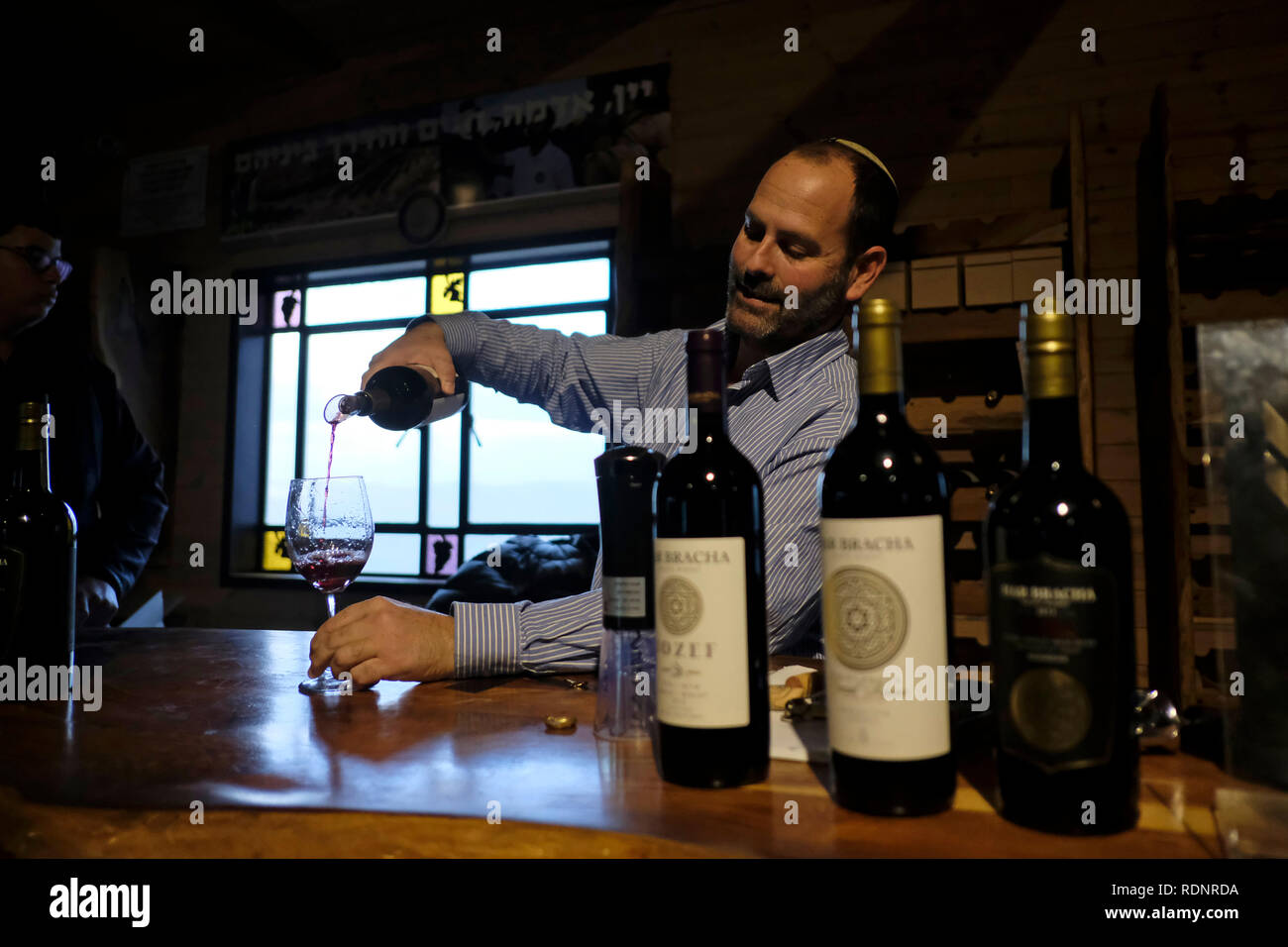Nir lavi, wine maker and owner of Har Bracha wines pours red wine at ...